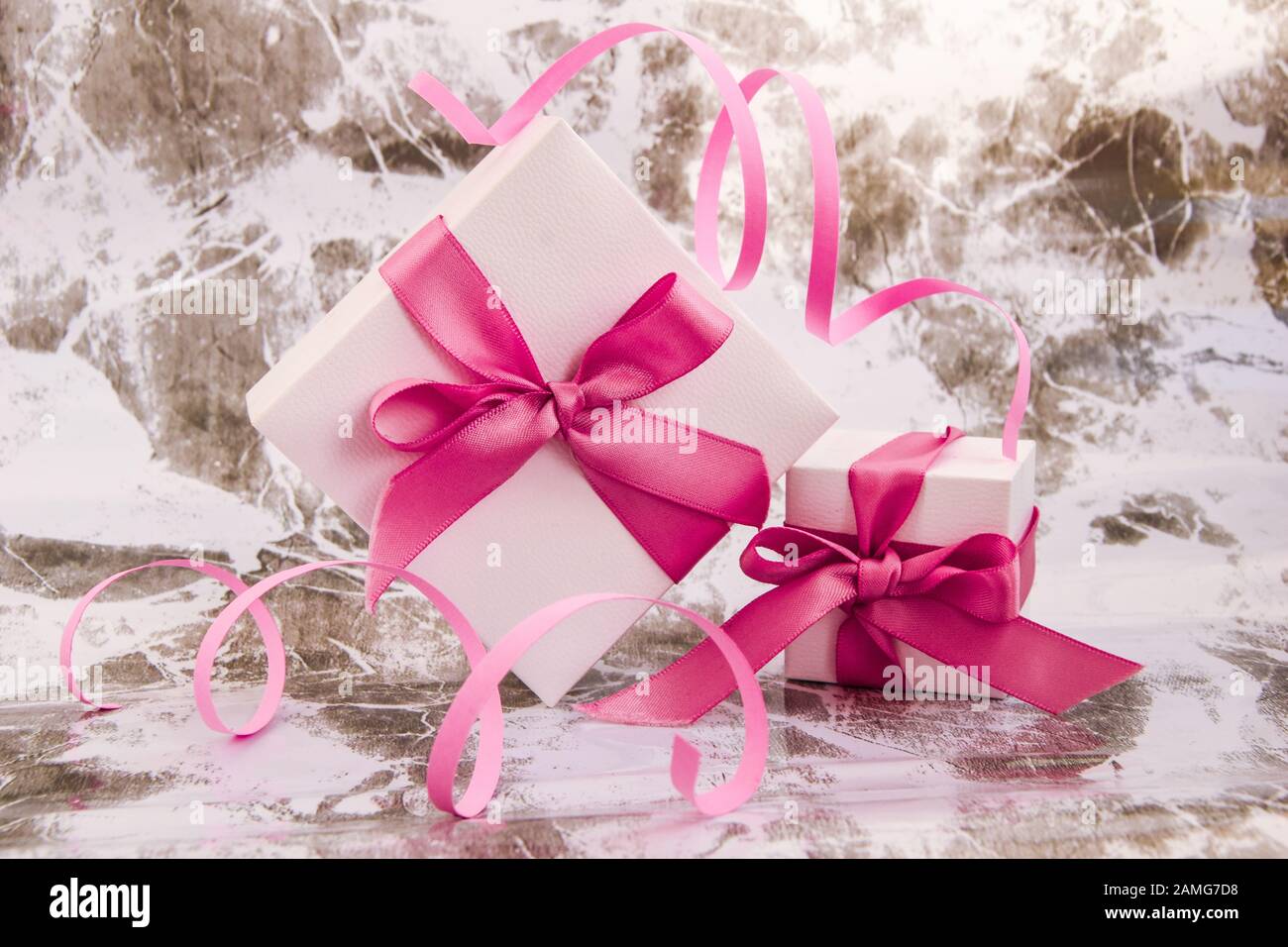 Two White present boxes with pink ribbon Stock Photo - Alamy