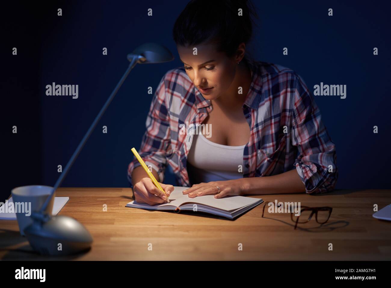 Tired female student learning till late at home Stock Photo - Alamy