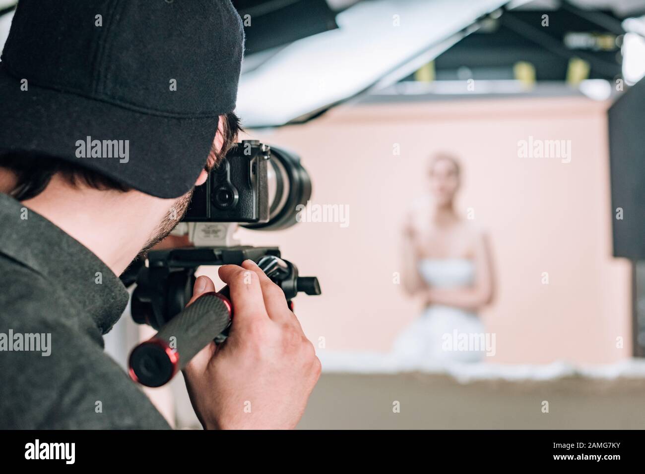 Back view of operator and model working in photo studio Stock Photo - Alamy