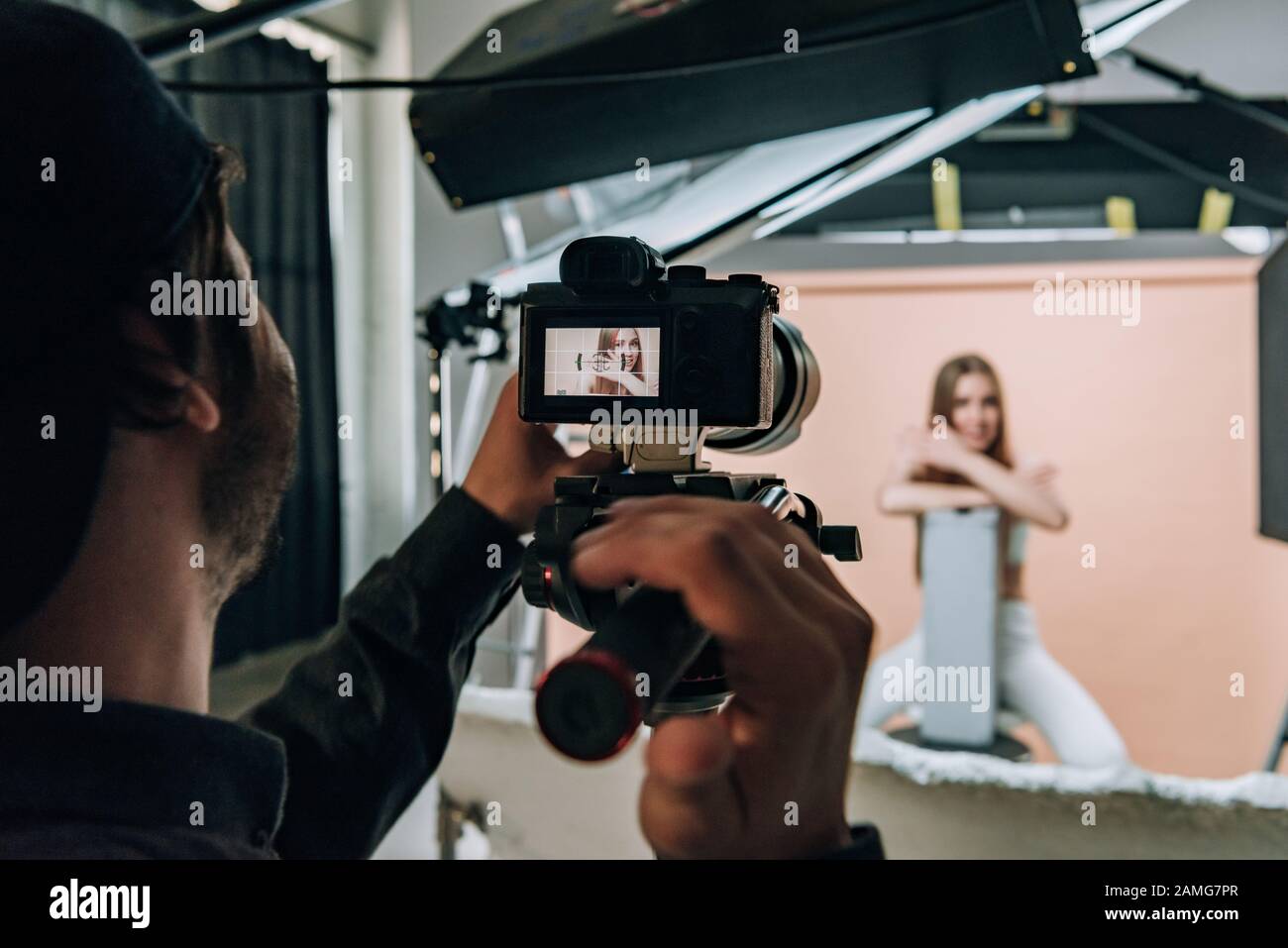Over shoulder view of videographer filming beautiful model in photo ...