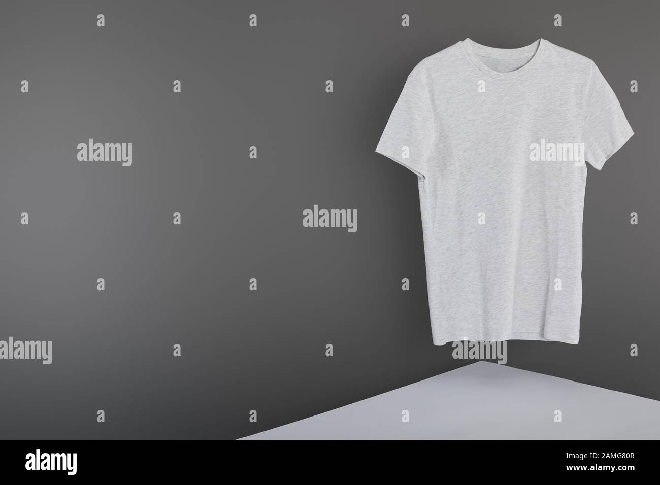 blank basic black t-shirt on black background Stock Photo - Alamy