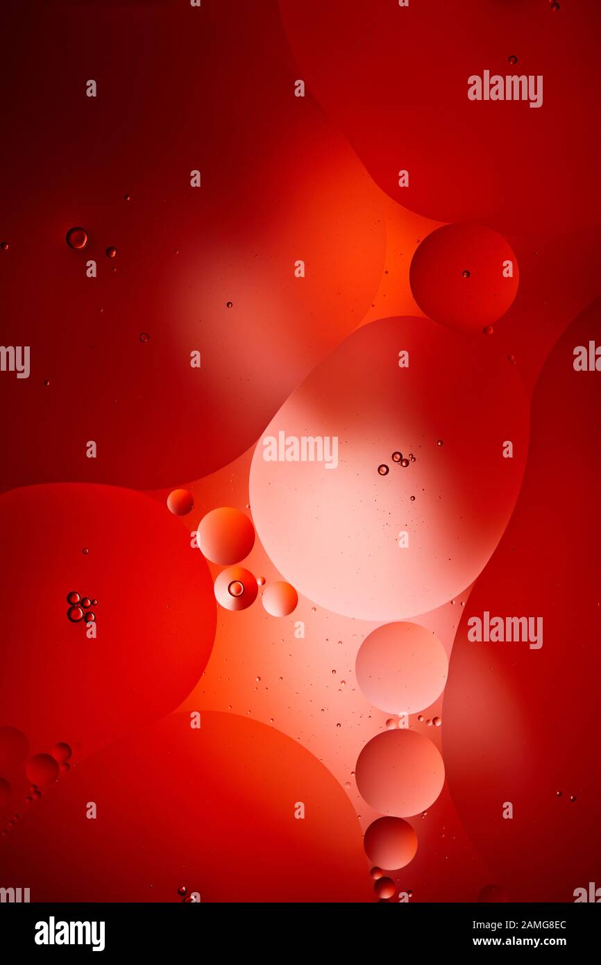 creative abstract red color background from mixed water and oil bubbles ...