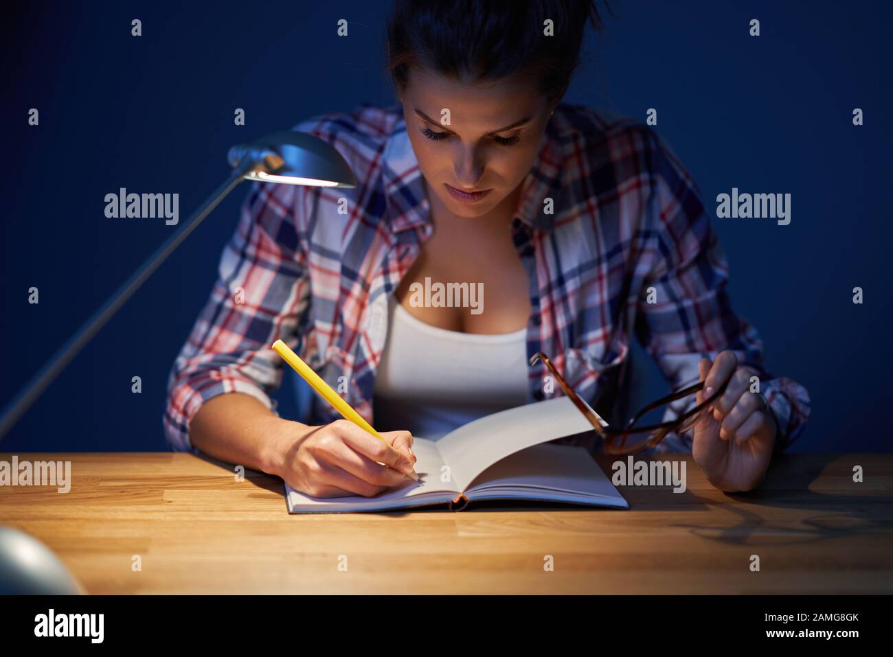 Tired female student learning till late at home Stock Photo - Alamy