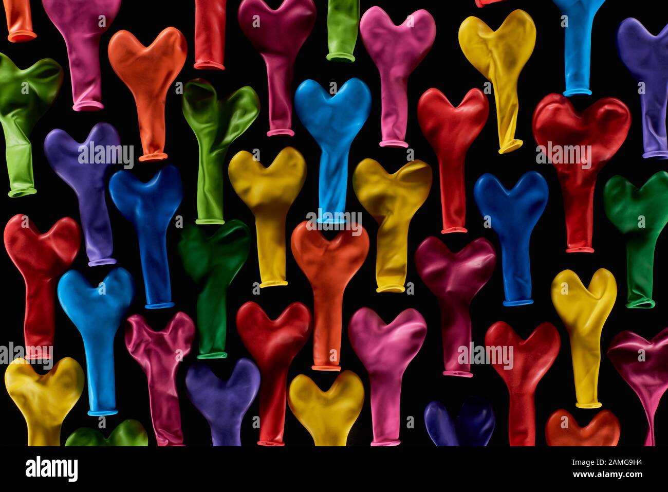 Top view of rubber heart shaped balloons isolated on black Stock Photo ...