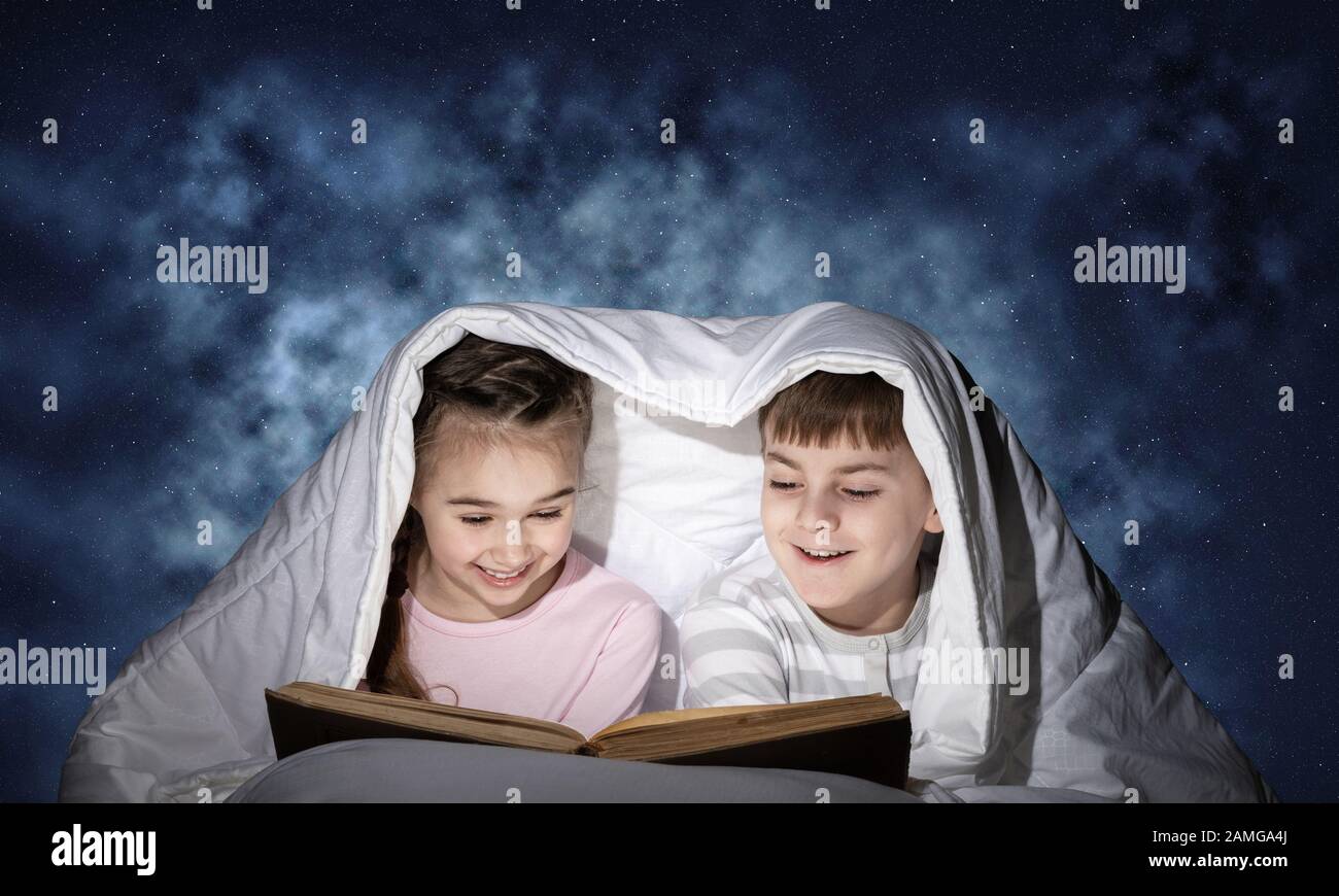 Happy children with flashlight hiding Stock Photo - Alamy