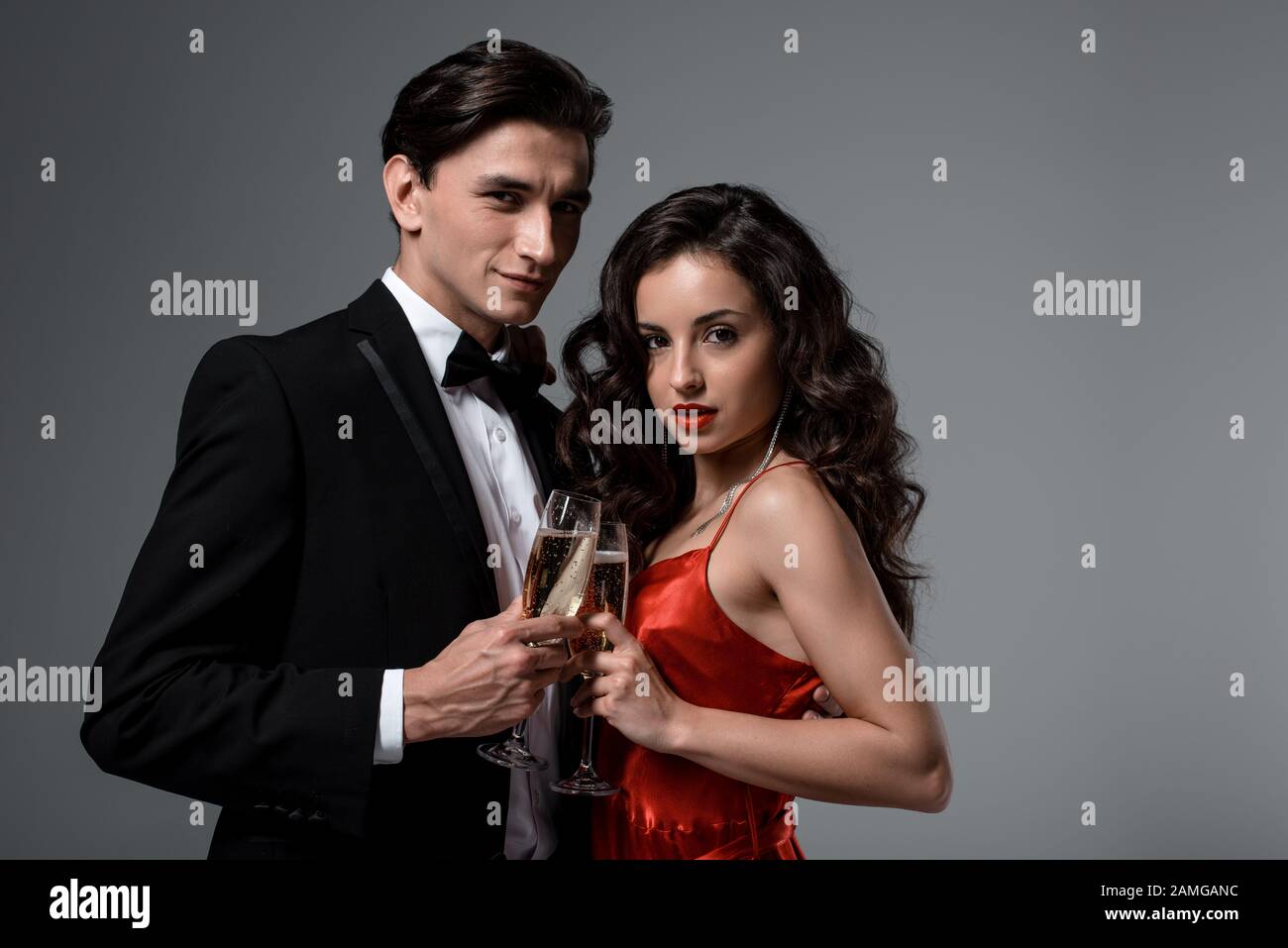 Romantic couple hugging and clinking with champagne glasses, isolated ...