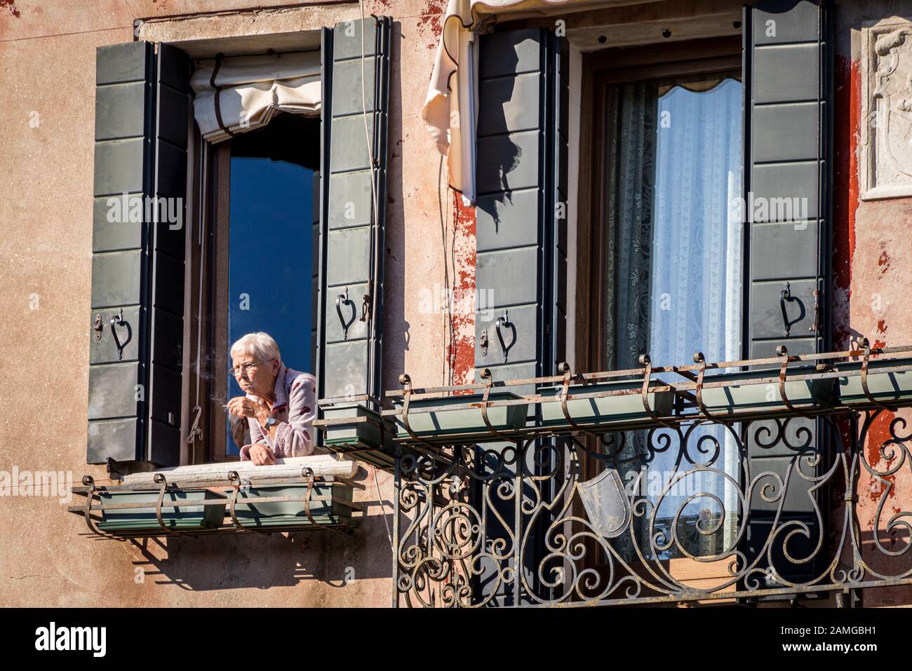 Woman smoking by window hi-res stock photography and images - Alamy