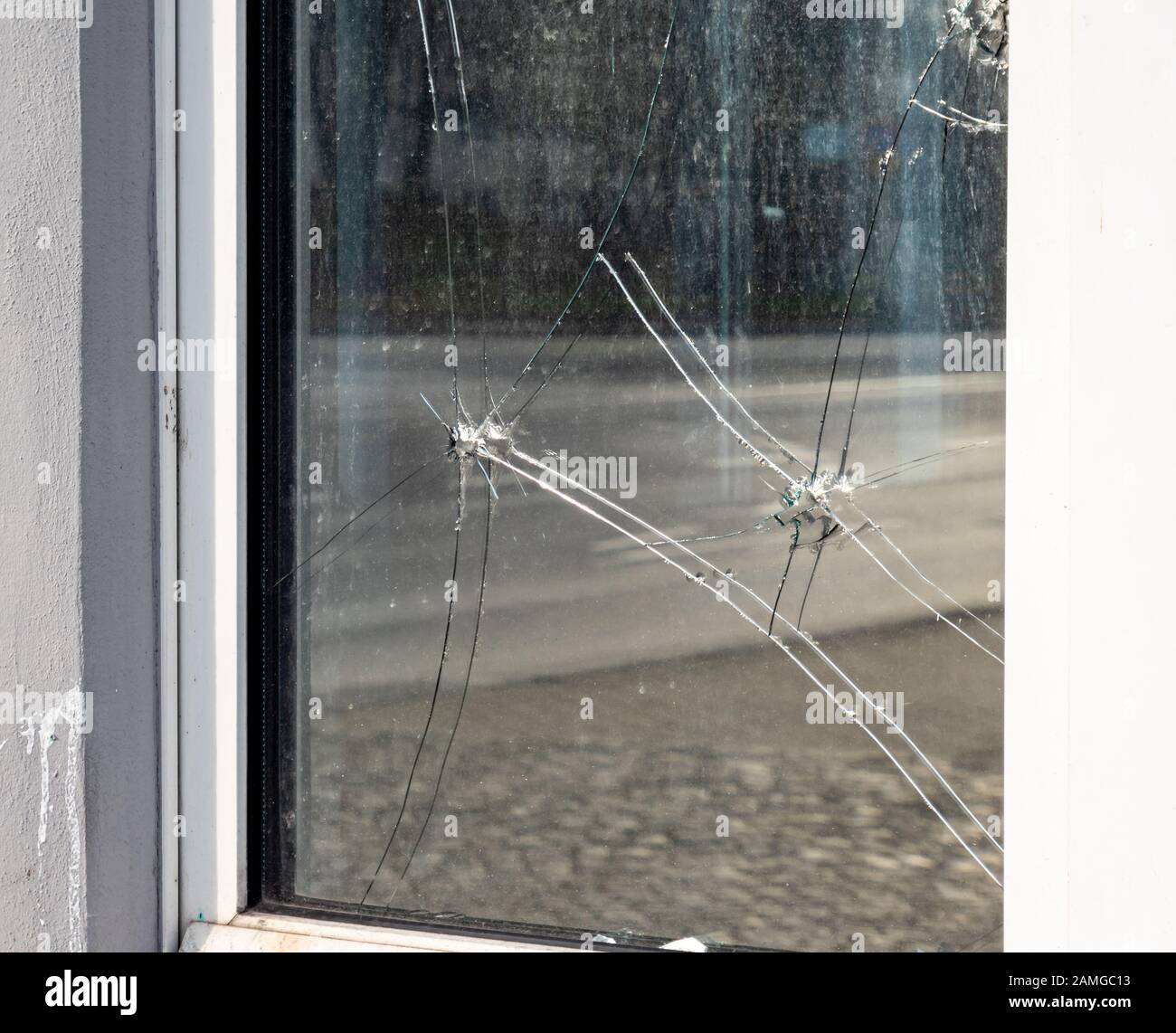 Bullet holes in a window pane Stock Photo - Alamy