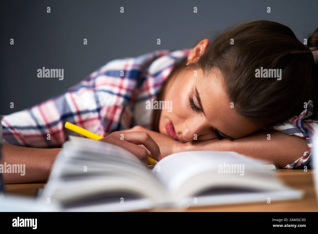 Tired female student learning till late at home Stock Photo - Alamy