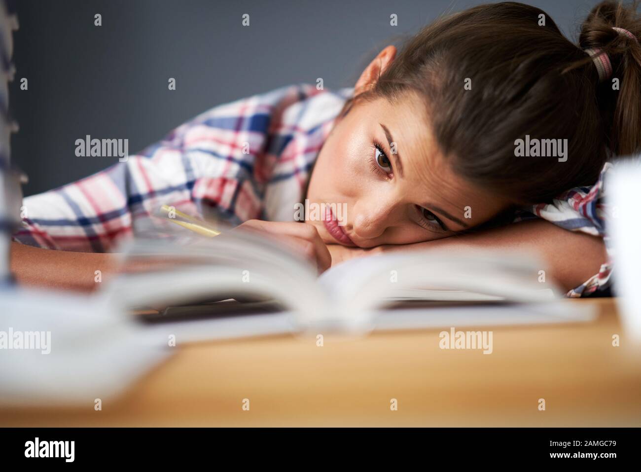 Tired female student learning till late at home Stock Photo - Alamy