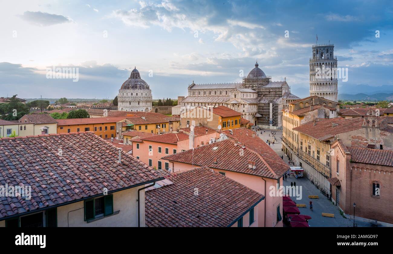 Pisa old town an sunset. View from the roofs to the old city, tower and ...