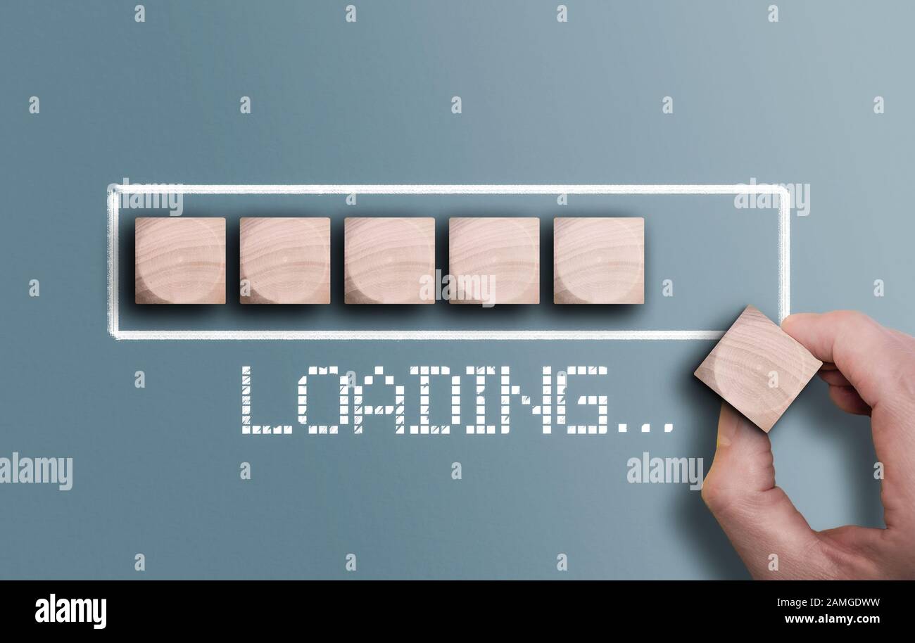 top view of hand holding wooden brick completing progress bar with text ...