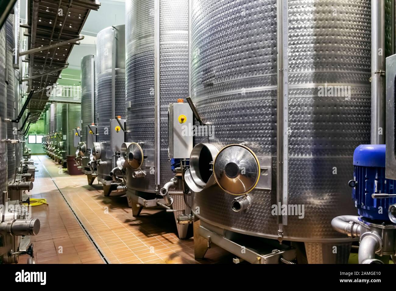 Metal silos for the fermentation of wine inside a farm. Storage of wine ...