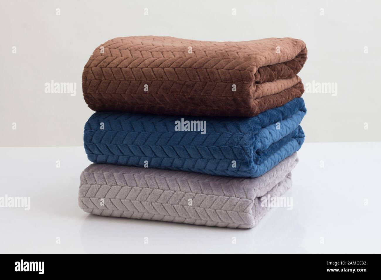 stack of folded soft blankets isolated on white background Stock Photo ...