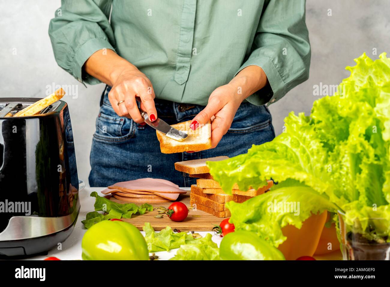 Girl smears butter on fried bread Stock Photo - Alamy