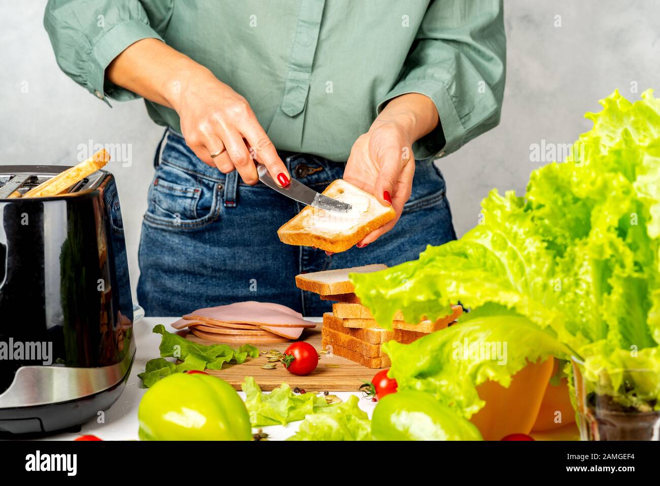 Girl smears butter on fried bread Stock Photo - Alamy