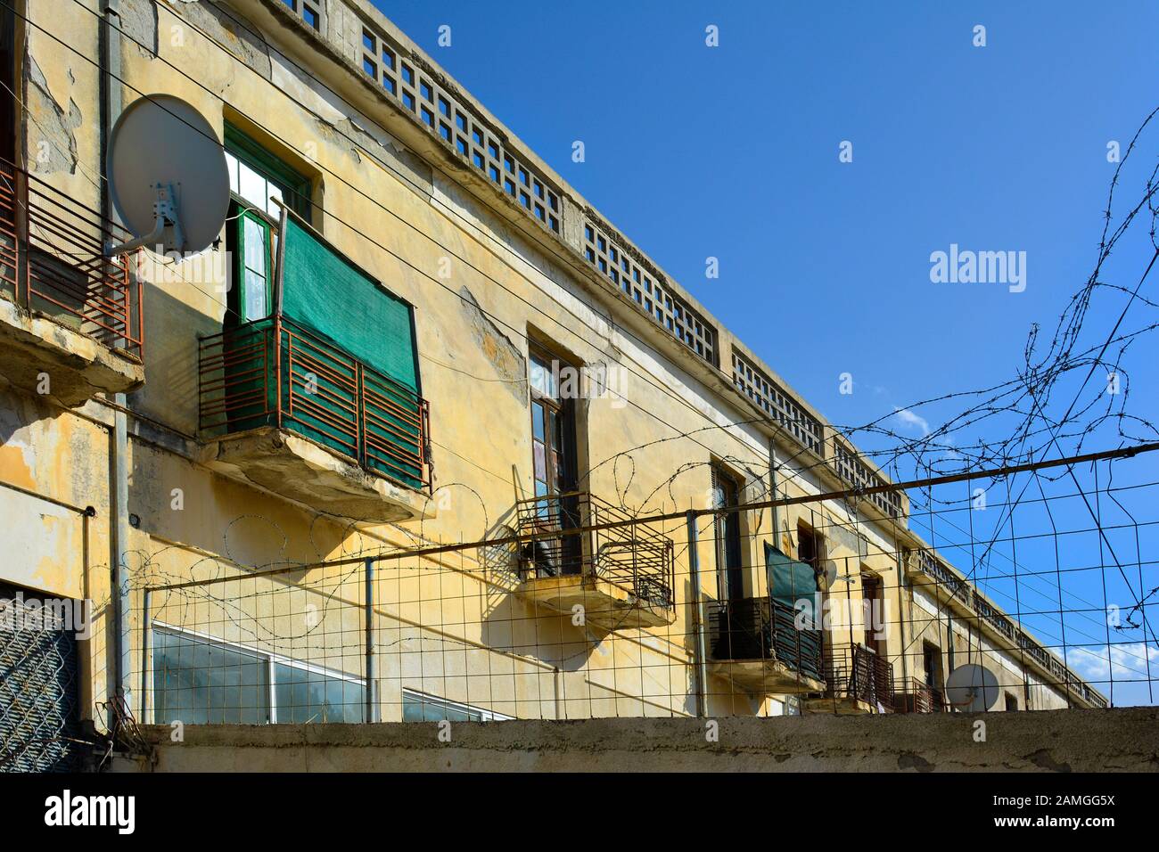 Cyprus, border with barb wired fence between buildings in the shared ...