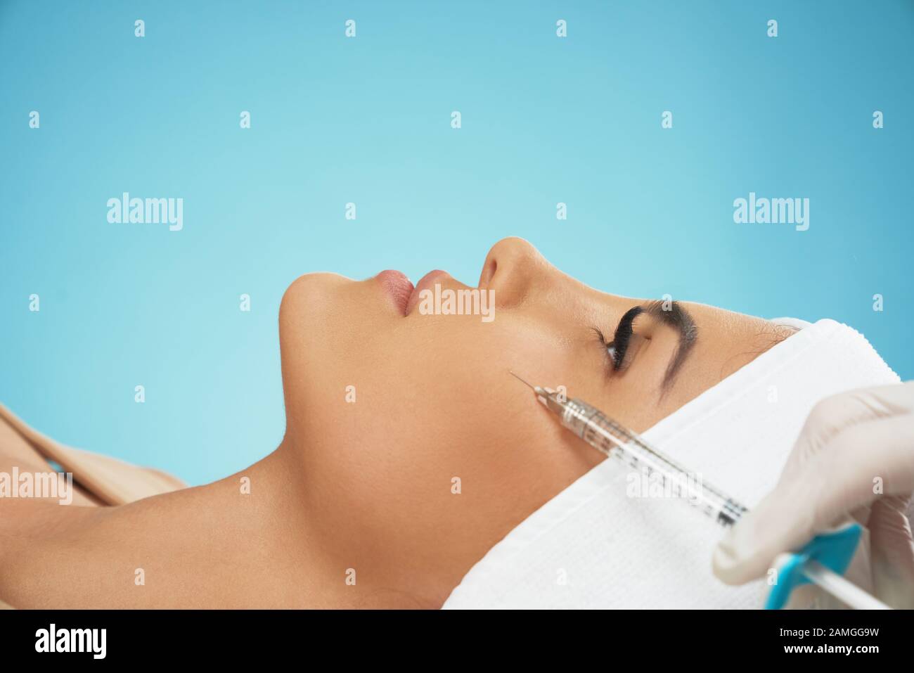 Close up of cosmetic botox injection in female cheek. Cosmetologist ...