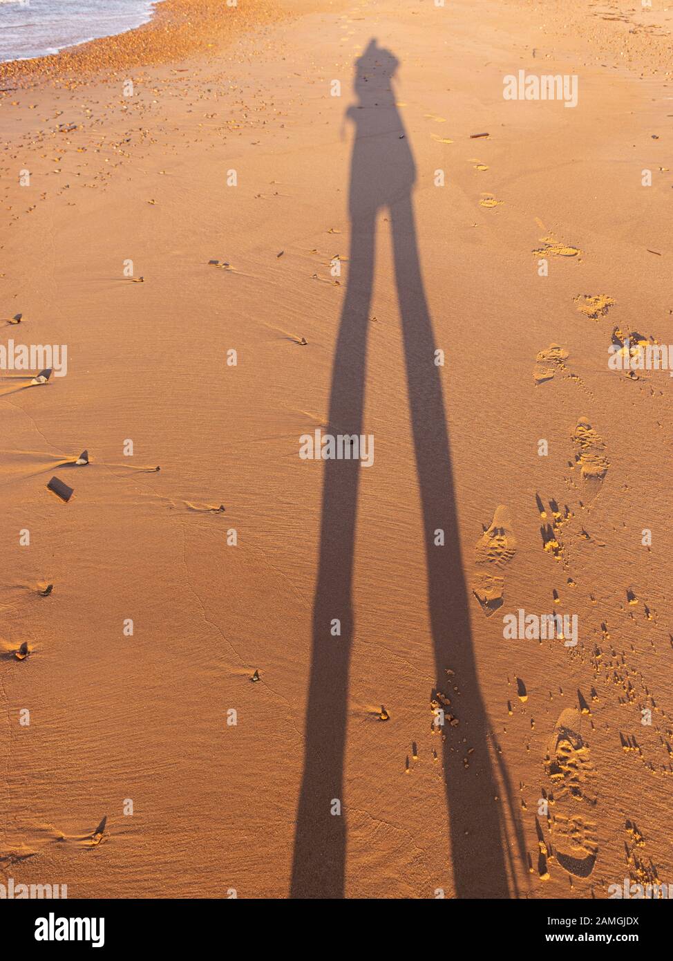 abstract picture with long human shadow, sea shore sand Stock Photo - Alamy