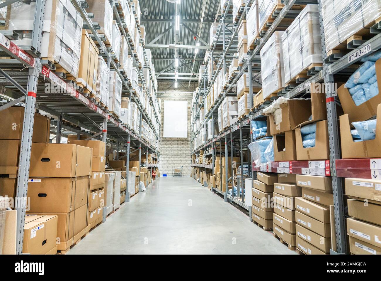 Rows of shelves with boxes in a modern warehouse Stock Photo - Alamy
