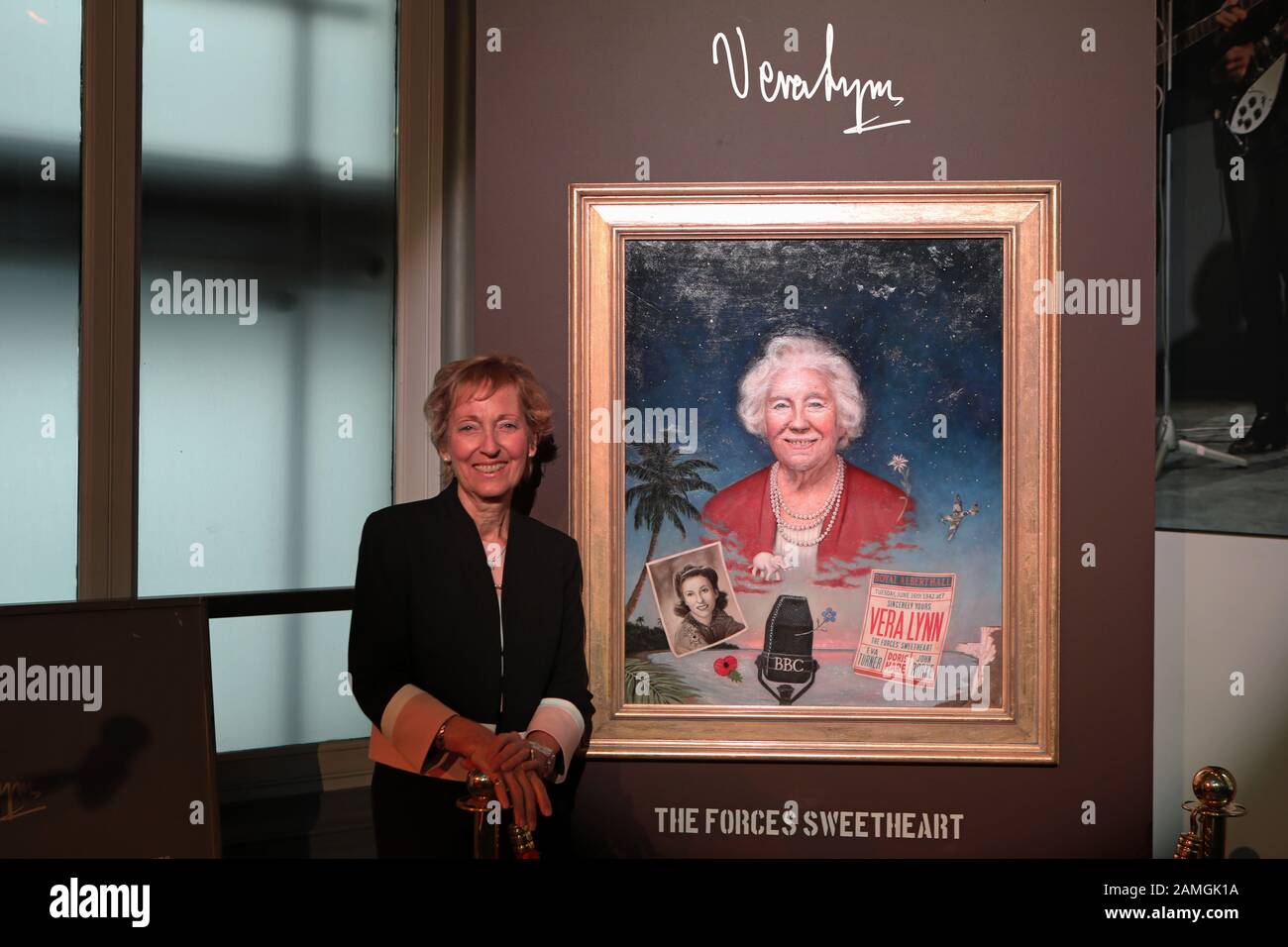 Virginia Lewis-Jones stands next to a painting by Norwegian artist Ross ...
