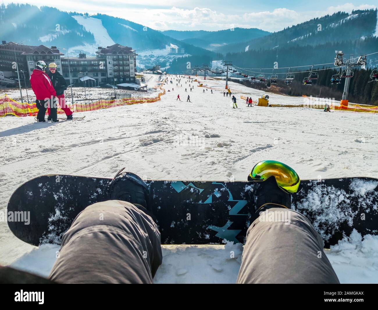 snowboarding concept sitting on the hill people skiing down Stock Photo ...