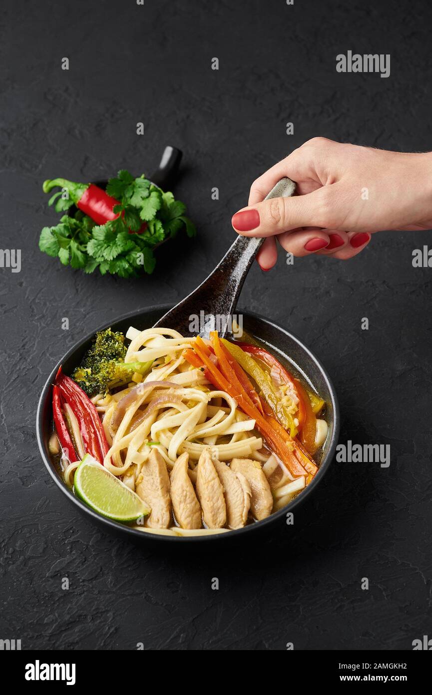 Chicken Thukpa in black bowl at dark slate background. Chicken Thukpa ...