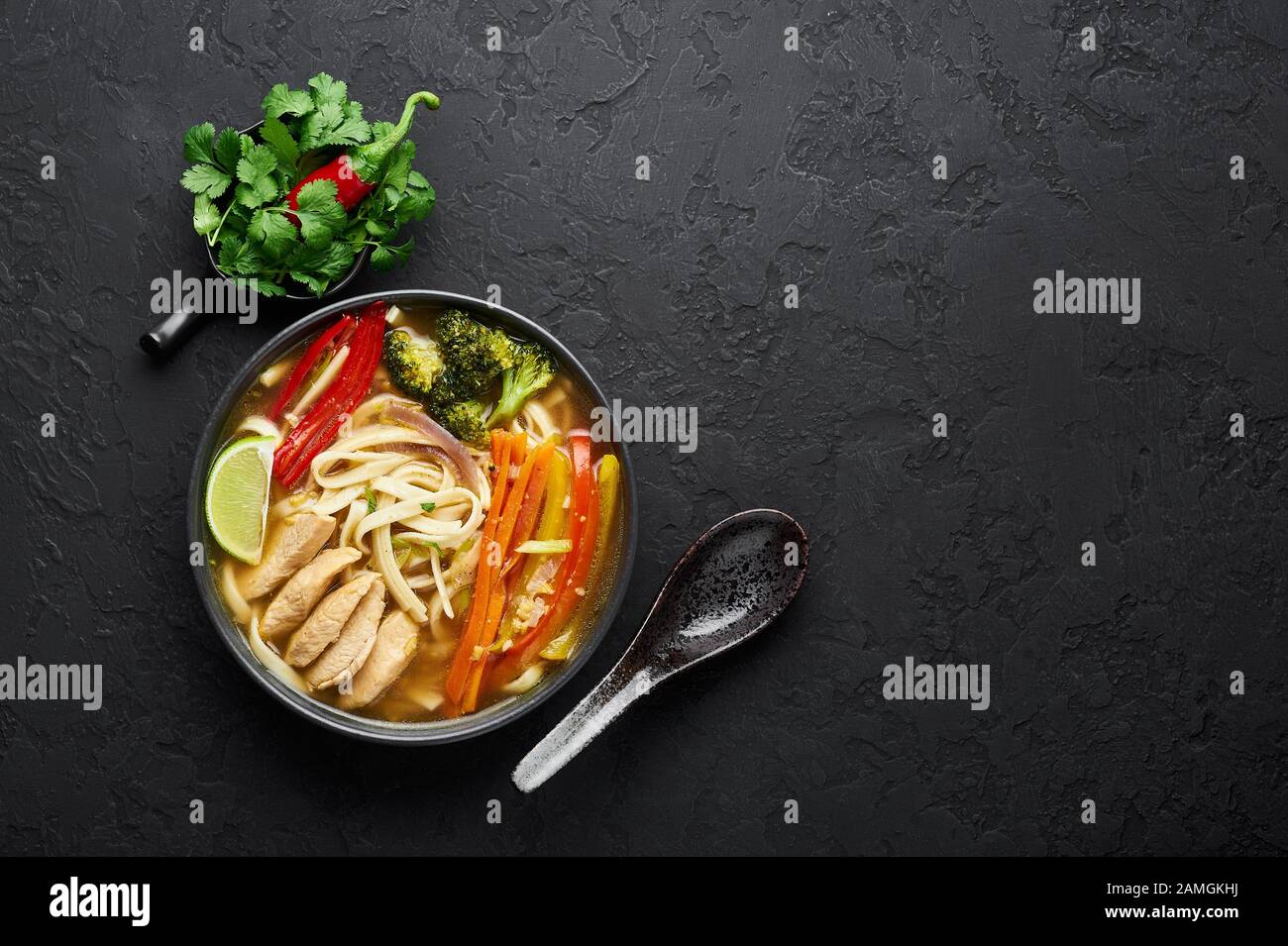 Chicken Thukpa in black bowl at dark slate background. Chicken Thukpa ...