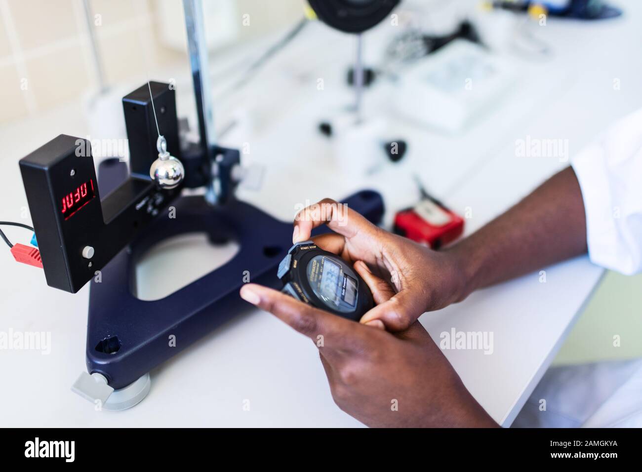 Scientist with laboratory clock and timer Stock Photo - Alamy