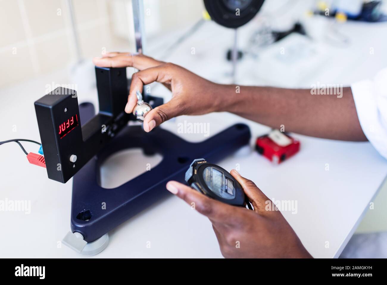Scientist with laboratory clock and timer Stock Photo - Alamy