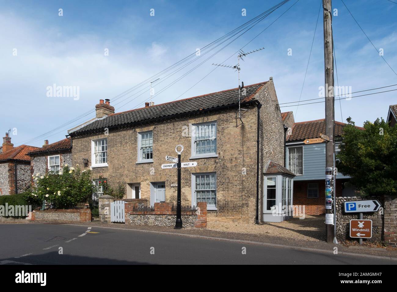 Traditional flint and stone houses in the village of Cley Next The Sea ...
