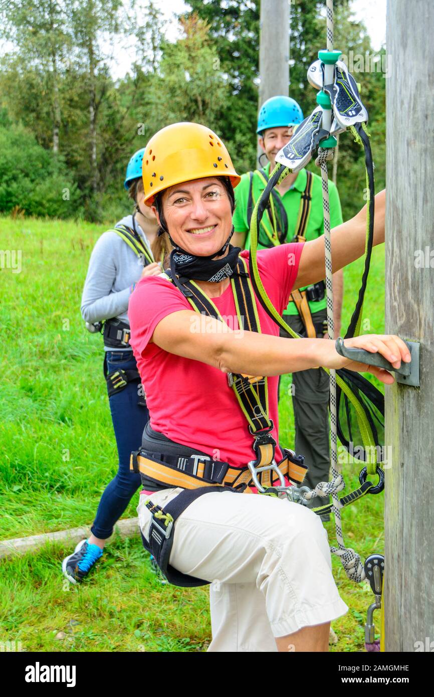 Funny afternoon in high ropes course Stock Photo - Alamy