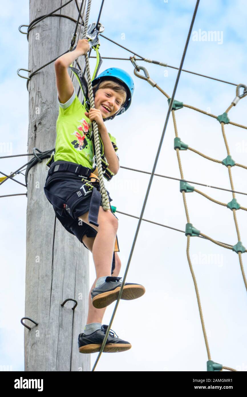 Funny afternoon in high ropes course Stock Photo - Alamy