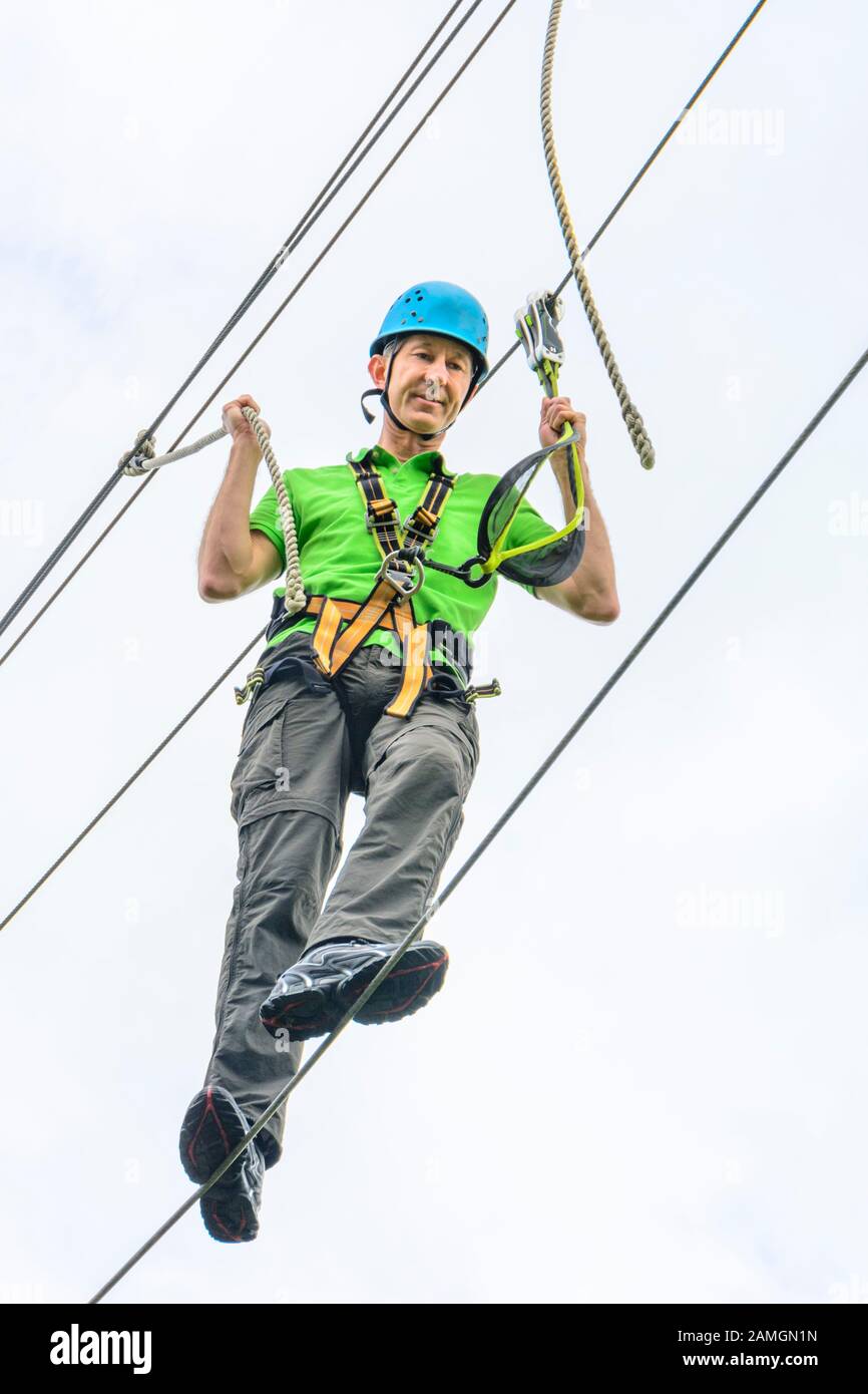 Funny afternoon in high ropes course Stock Photo - Alamy