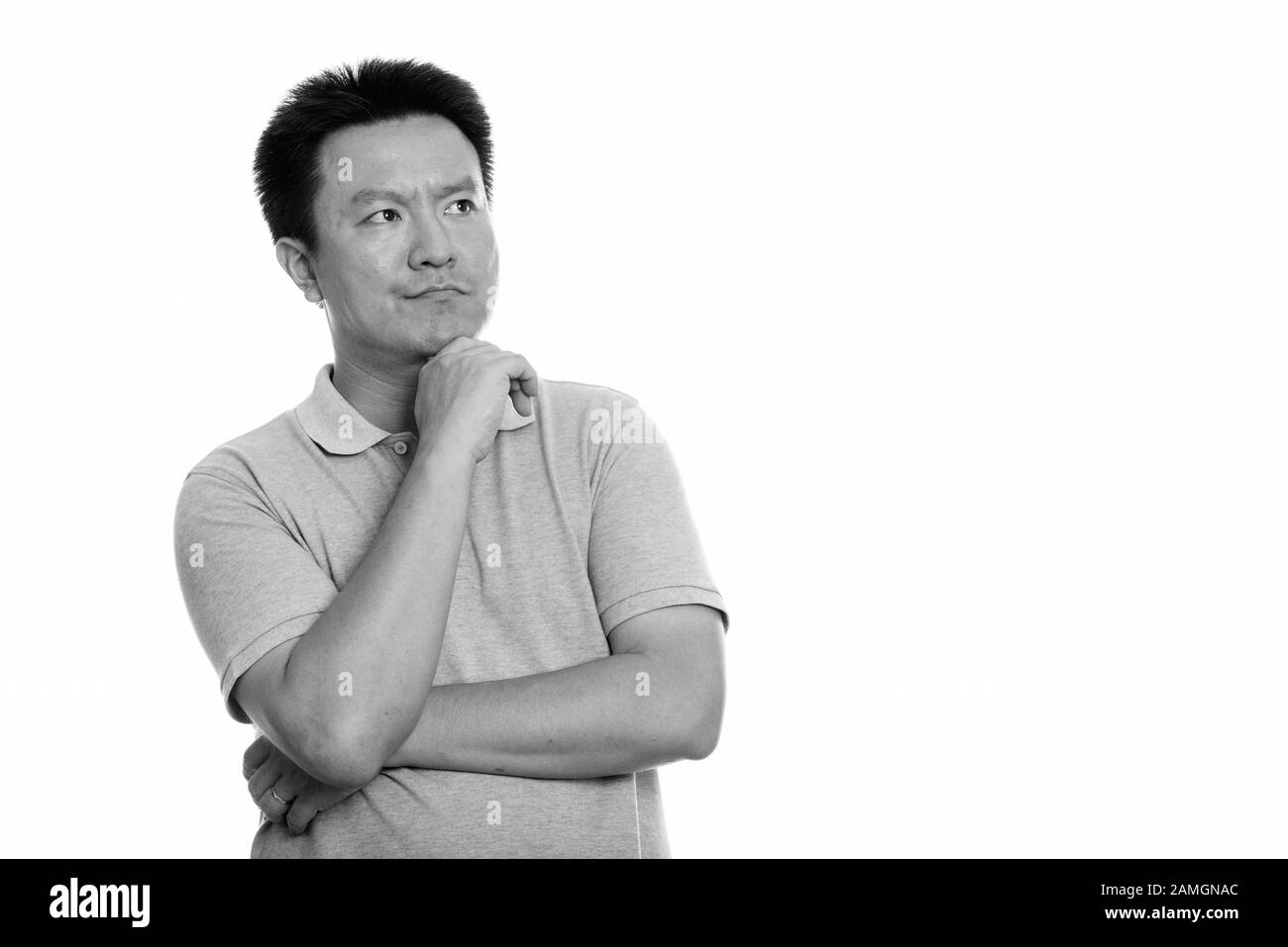 Studio shot of Japanese man thinking while looking up Stock Photo - Alamy