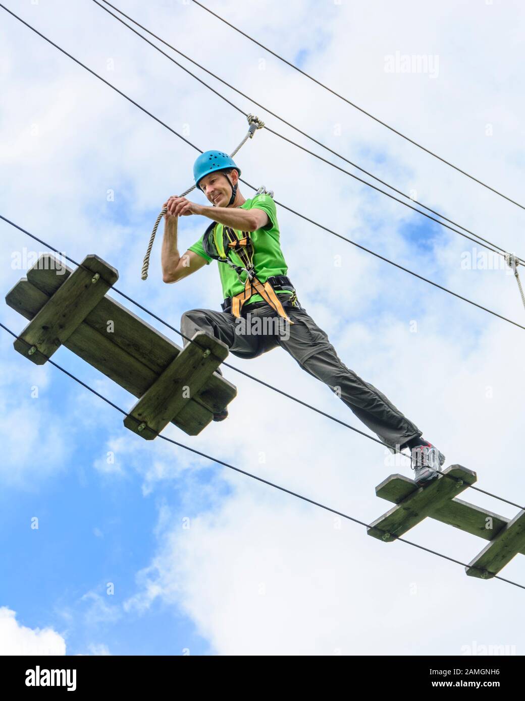 Funny afternoon in high ropes course Stock Photo - Alamy