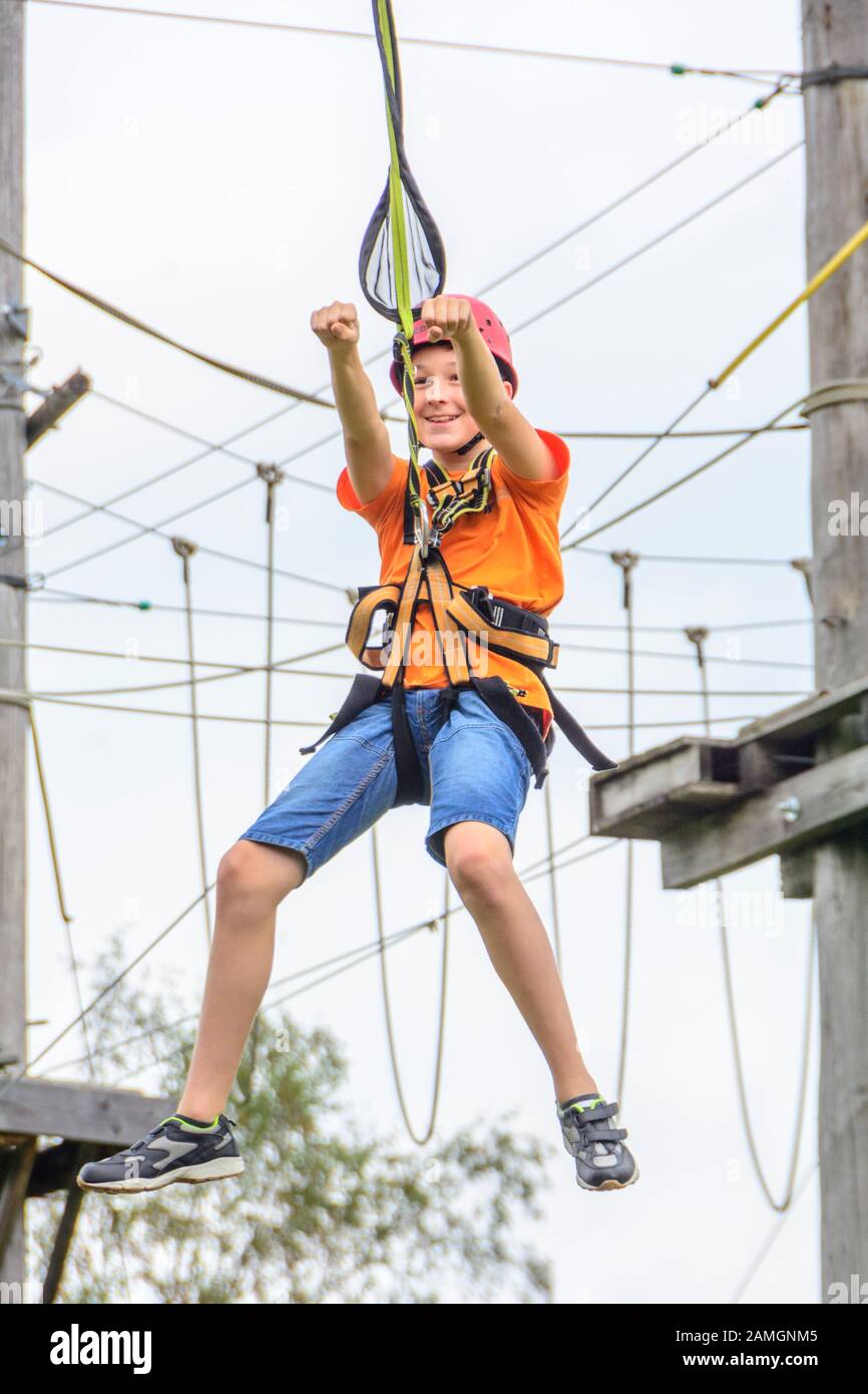 Funny afternoon in high ropes course Stock Photo - Alamy