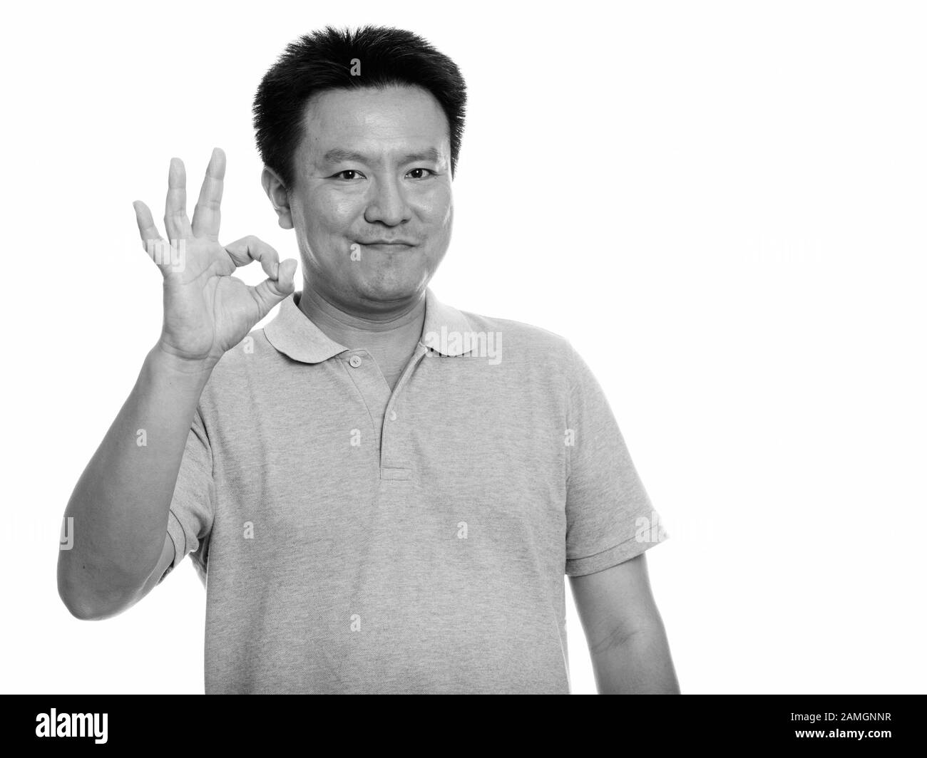 Studio shot of Japanese man giving ok sign Stock Photo - Alamy