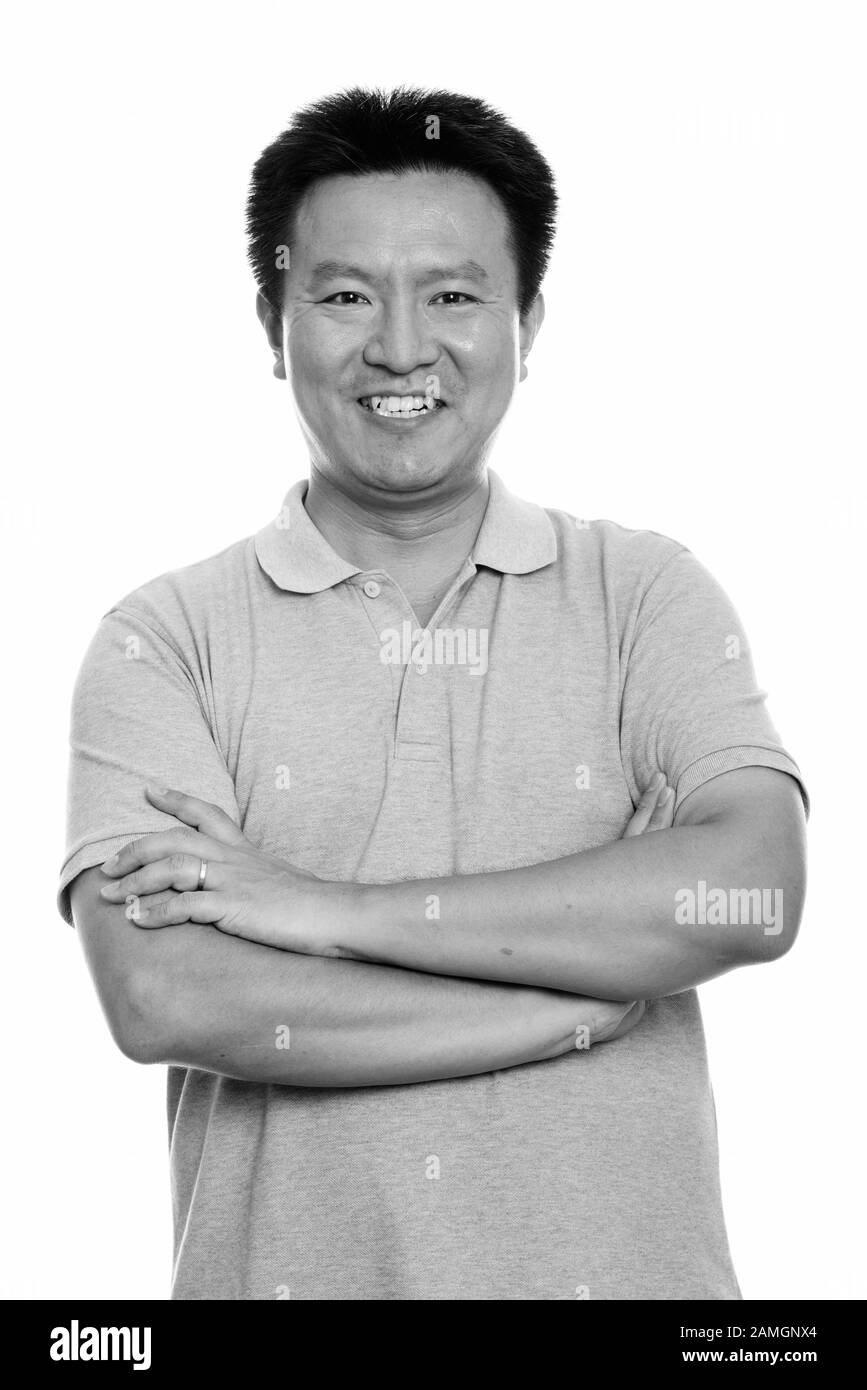 Studio shot of happy Japanese man smiling with arms crossed Stock Photo ...