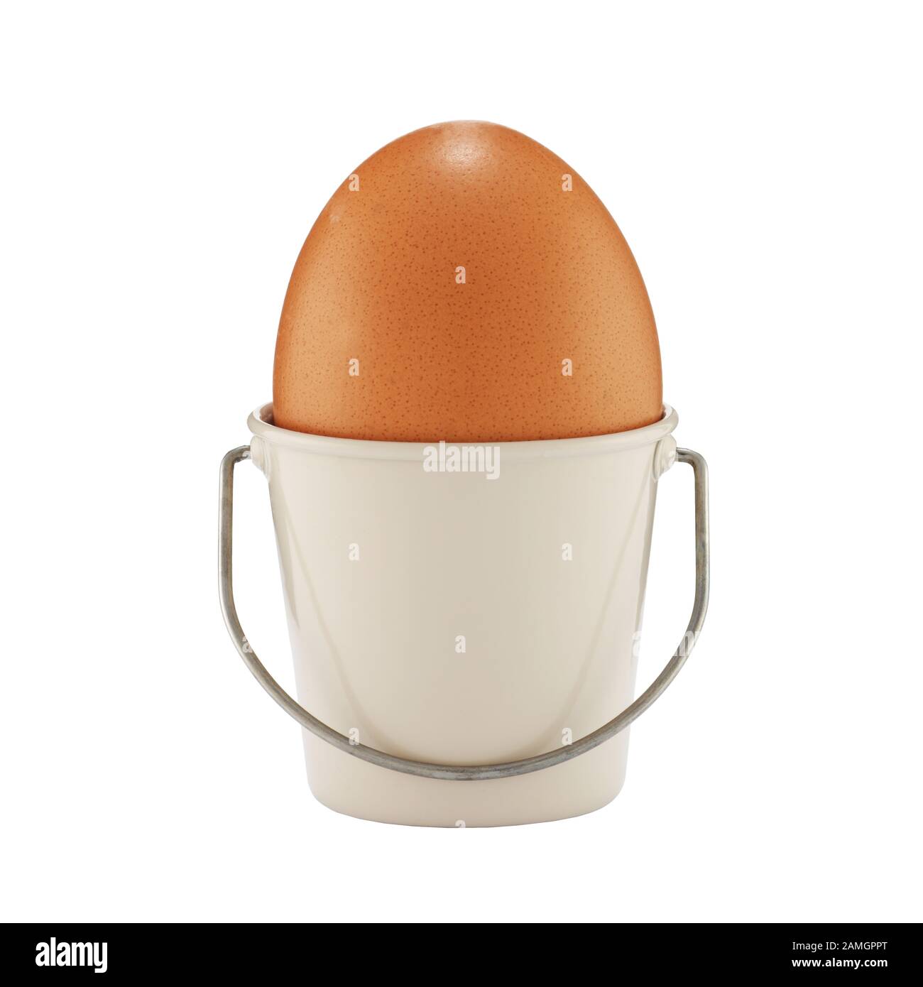 An egg in a bucket shaped eggcup on white with clipping path Stock ...