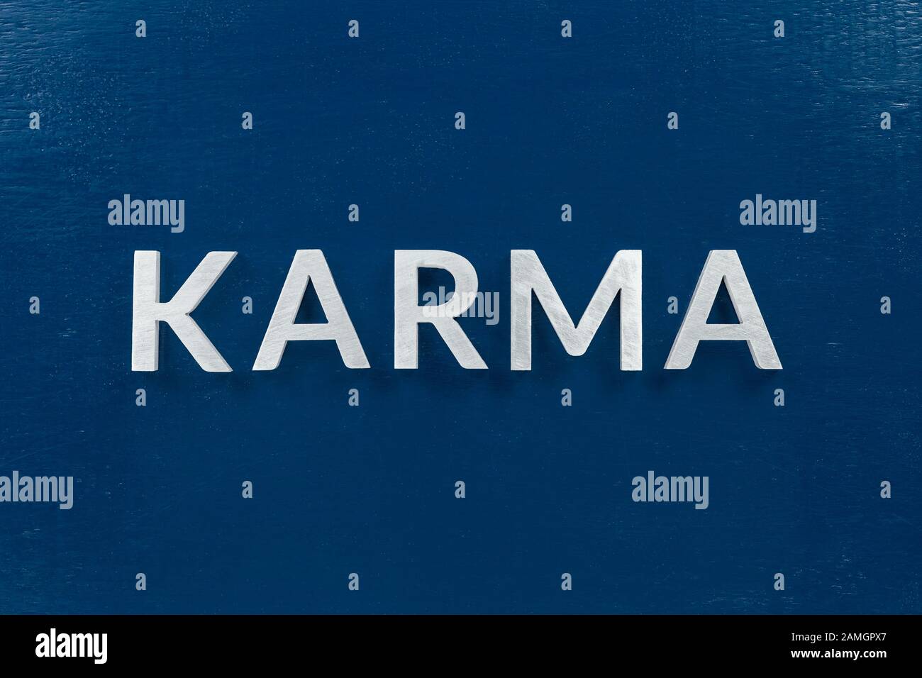 the word karma on classic blue background - on center of picture, laid ...