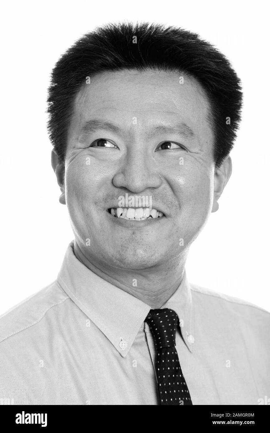 Face of happy Japanese businessman smiling while thinking Stock Photo ...