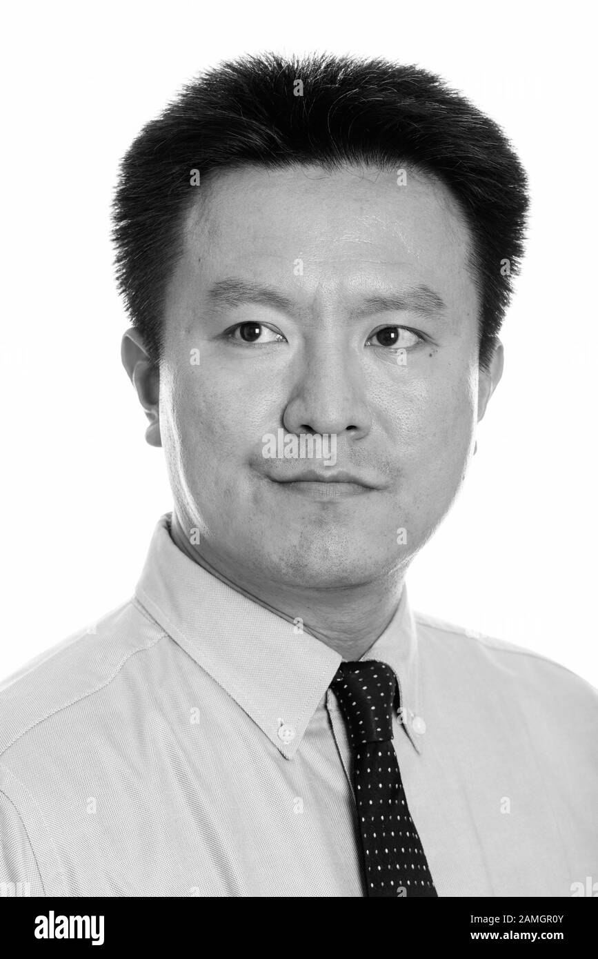Face of Japanese businessman thinking and looking up Stock Photo - Alamy