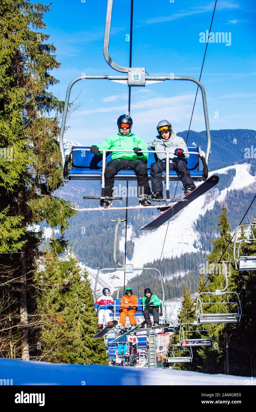 BUKOVEL, UKRAINE - February 10, 2019: people at ski lift in mountains ...