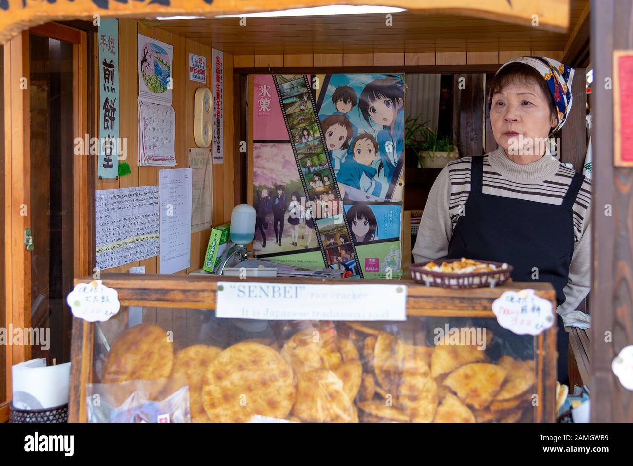 Takayama, Japan - April 26, 2014: Saleswoman inside his senbei store at ...