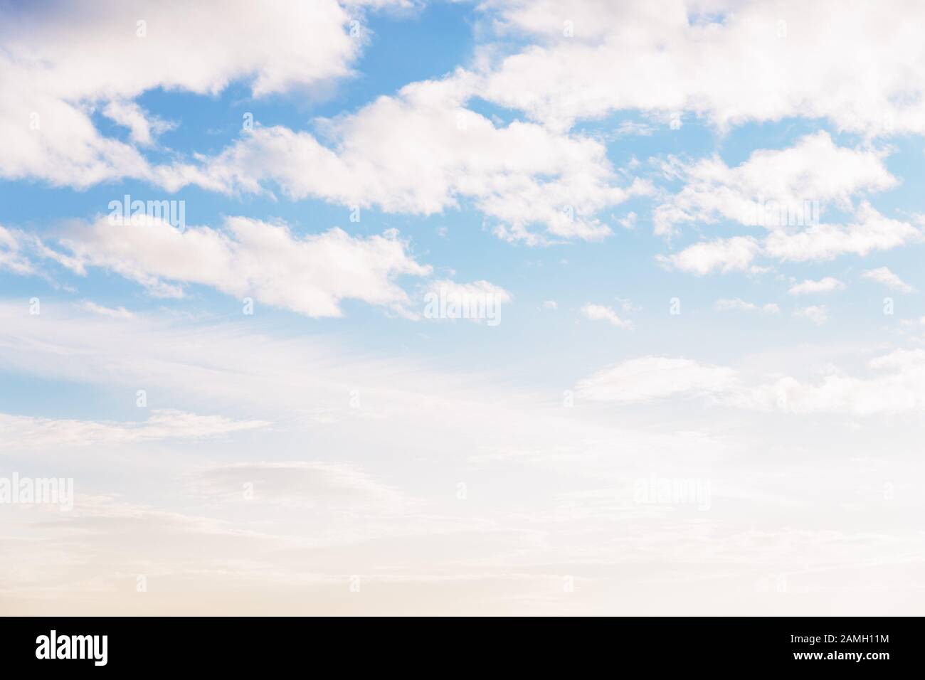 Scenic sky. Beautiful white clouds on a pale blue sky background. Copy ...