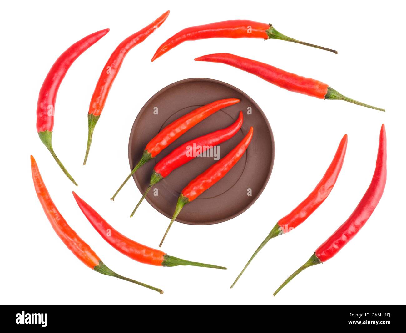 Red chili pods on brown clay plate and on white isolated background ...