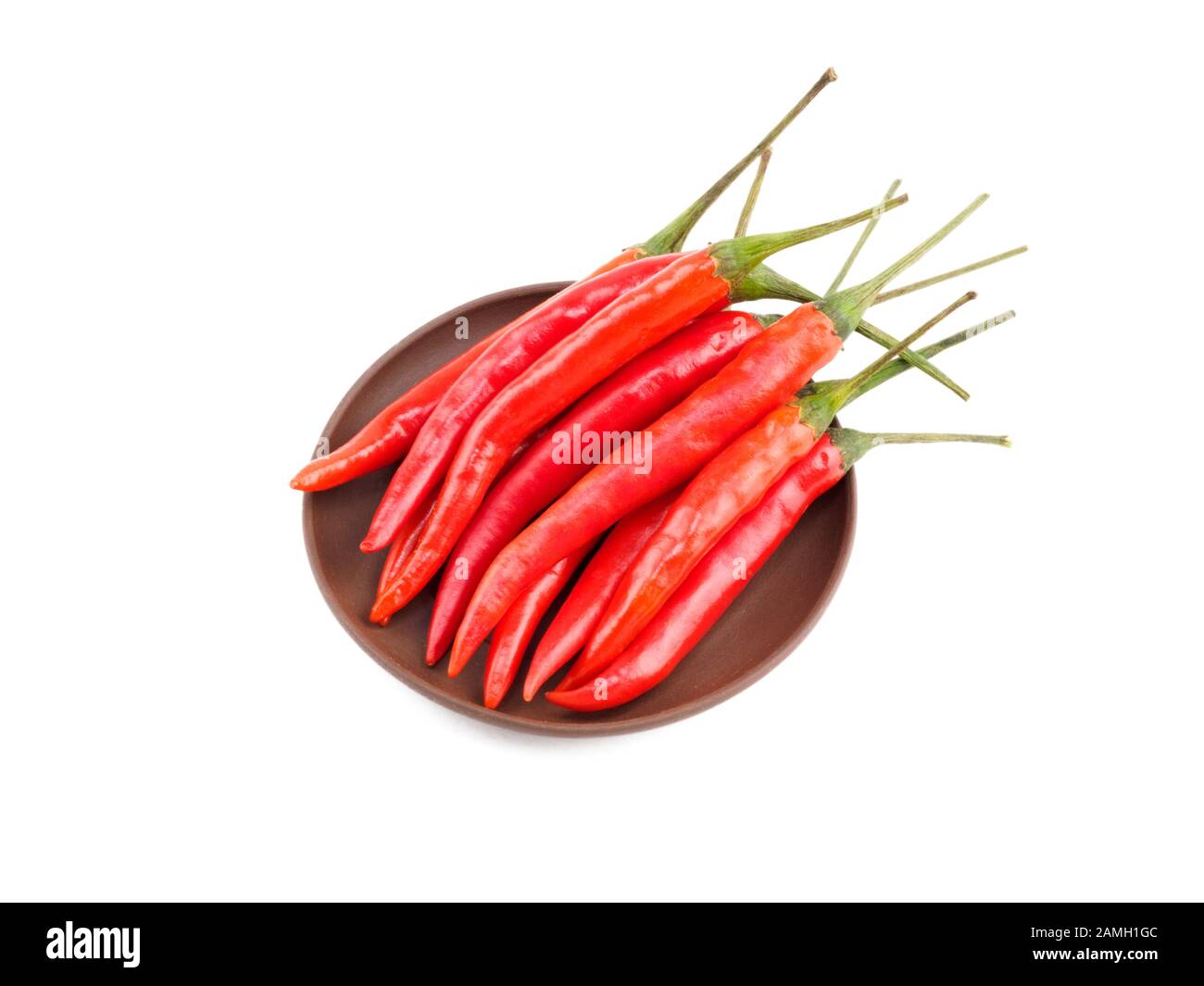 Red chili pods in clay plate isolated on white background Stock Photo ...