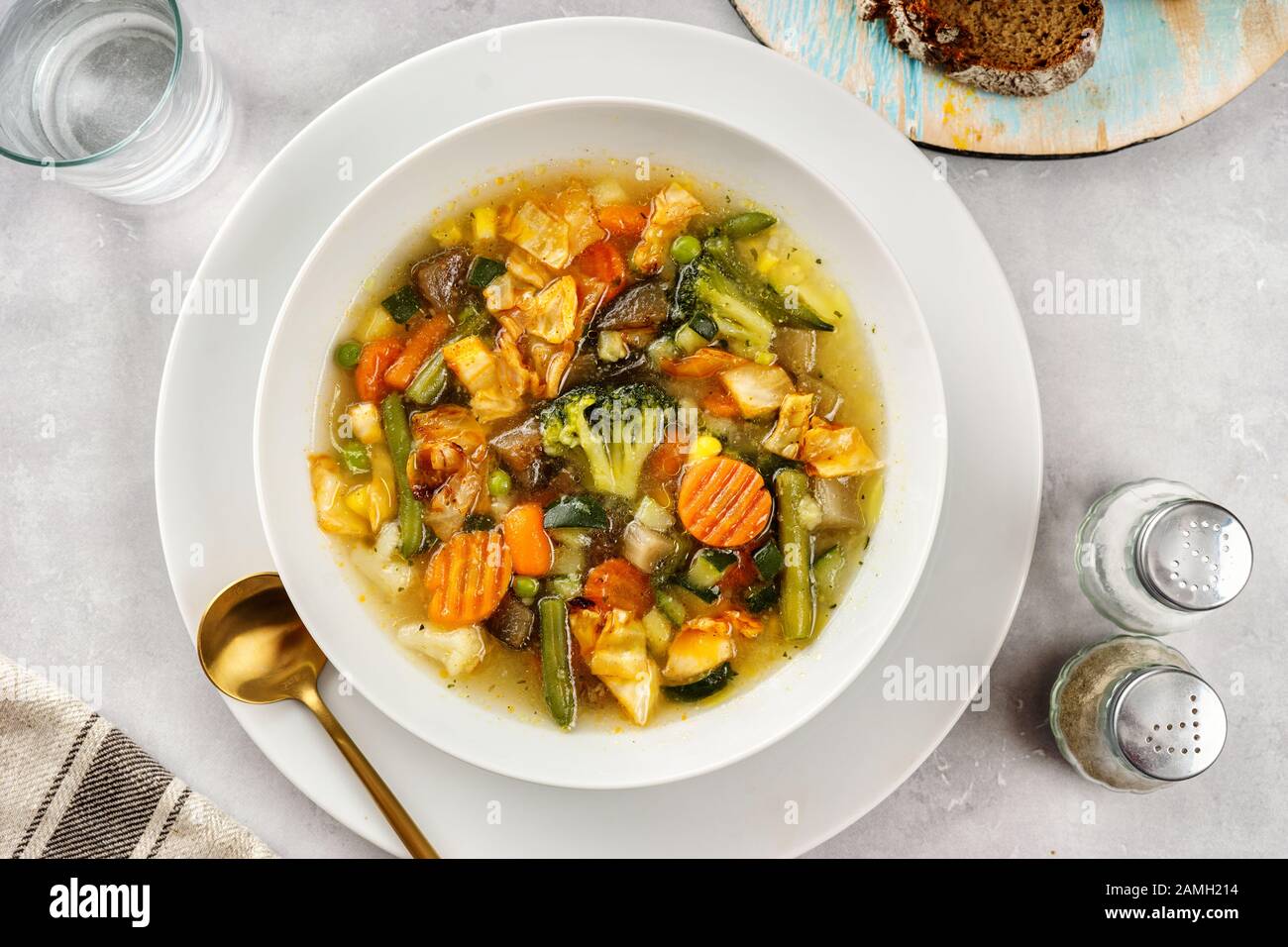 Spring vegetable soup on light background Stock Photo - Alamy