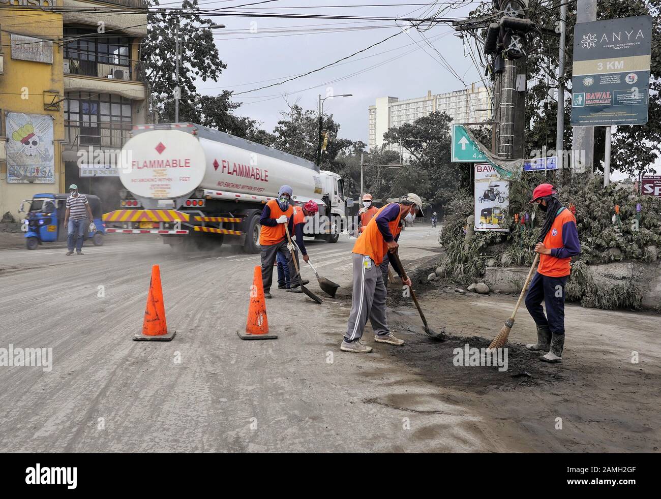 Tagaytay, Cavite, Philippines. 13th Jan, 2020. Workers clean ash from ...